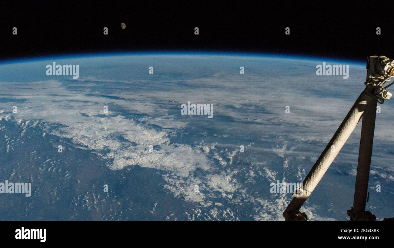 The waxing gibbous Moon appears above Earth’s horizon while the ISS ...