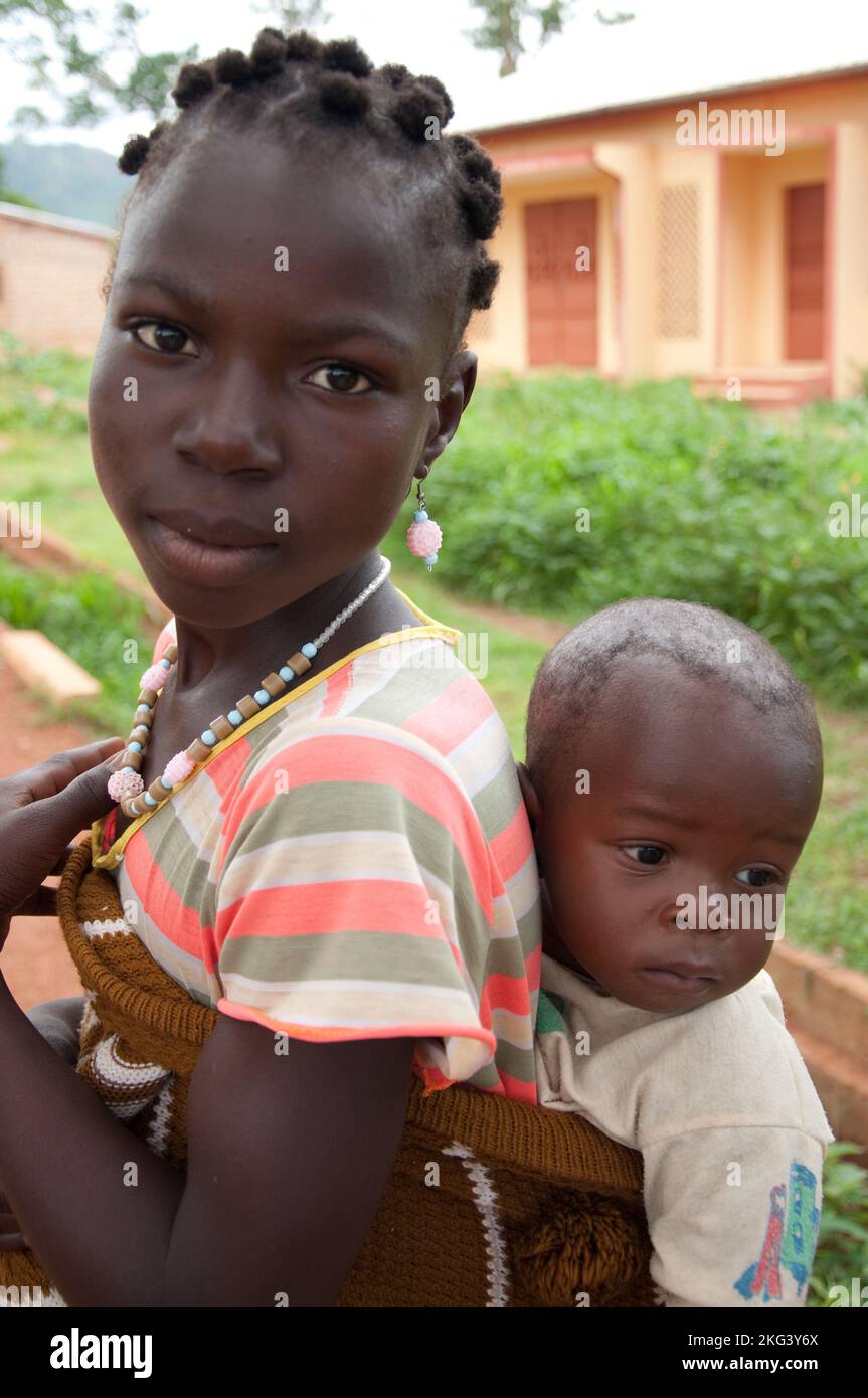young mother and baby, Tangueta, Atacora, Benin. As usual the baby is ...