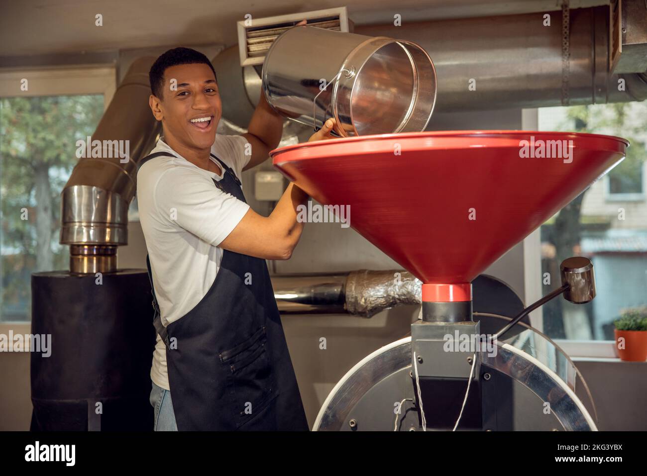 Joyful roast master posing for the camera at work Stock Photo - Alamy