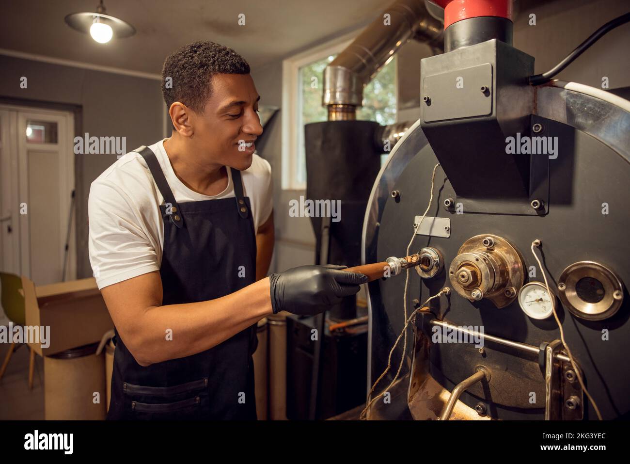 Roast master checking the roast degree of coffee beans Stock Photo - Alamy