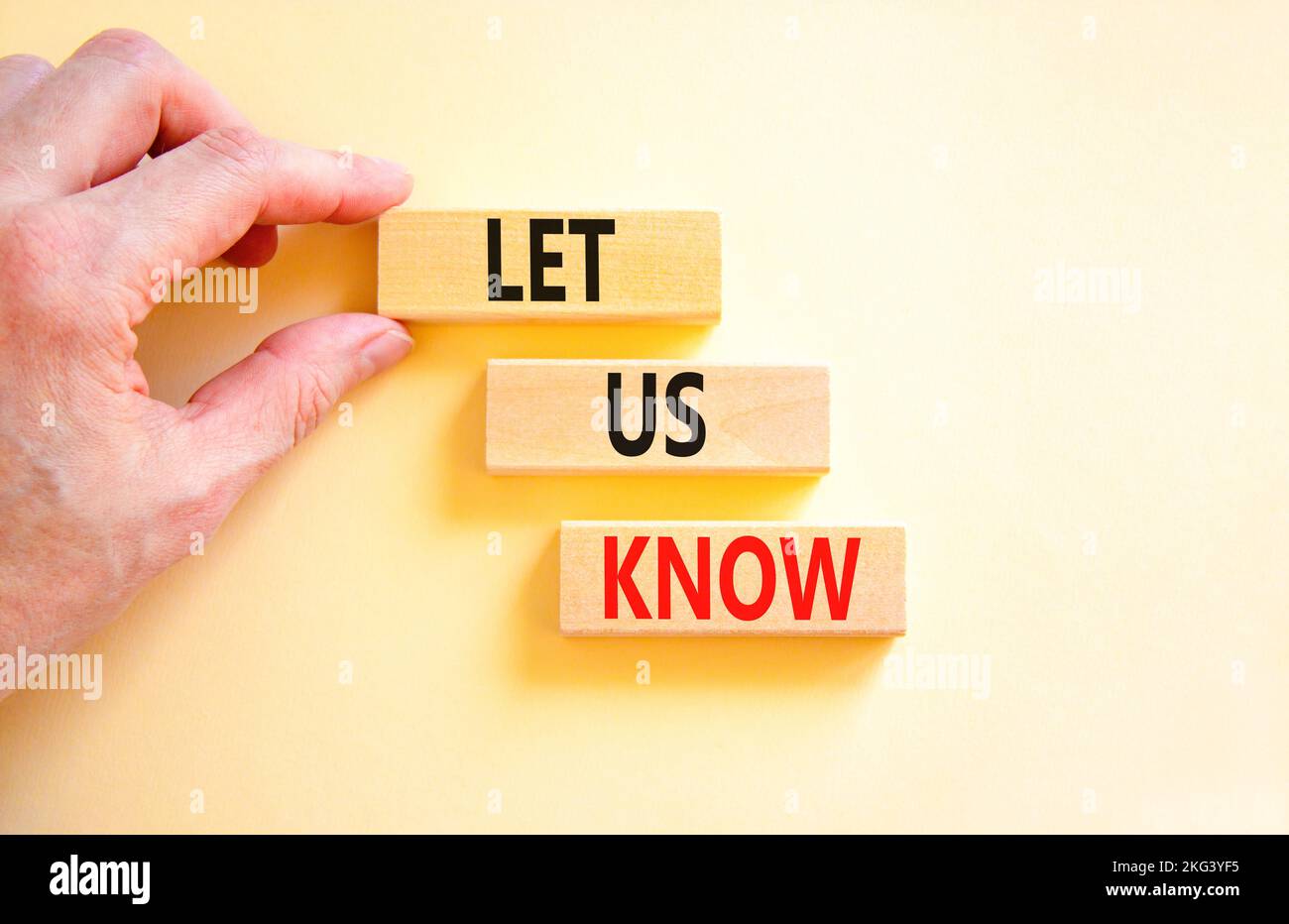 Let us know symbol. Concept words Let us know on wooden blocks on a ...