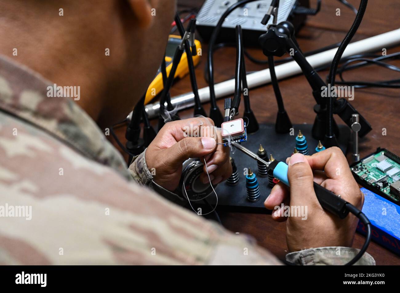 An Airman assigned to Task Force 99 solders components at Al Udeid Air ...