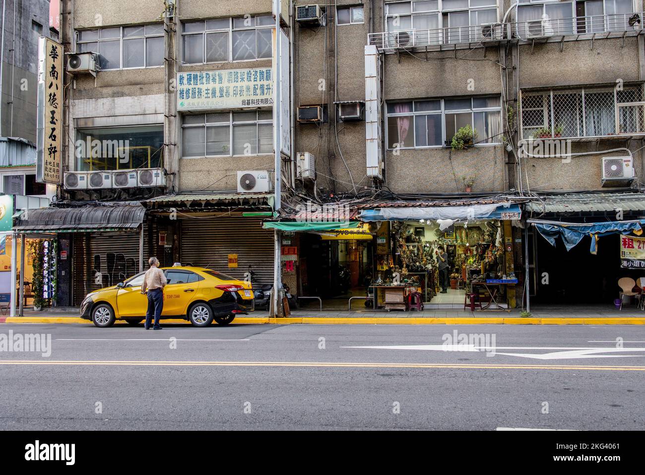A taxi driver is seen with his car on an empty road. (Photo by Hesther ...