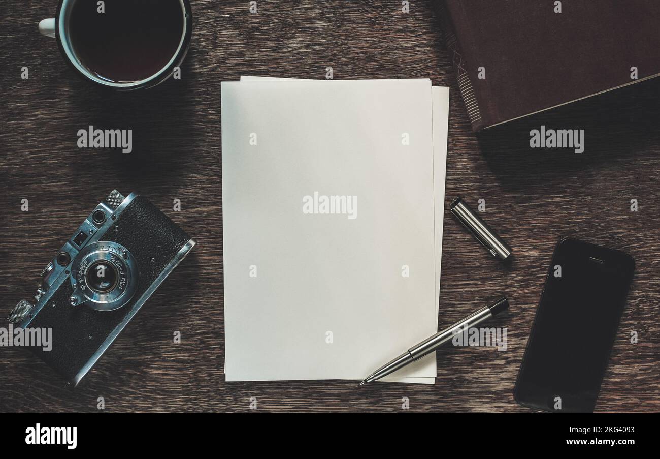 Writing a letter. Sheets of paper, pen, retro camera, cup of tea ...