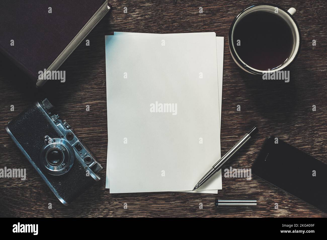 Writing a story. Sheets of paper, pen, retro camera, cup of tea ...