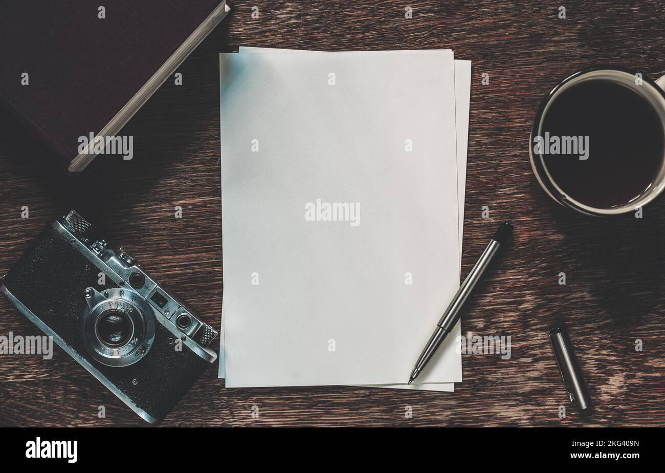 Writing a letter. Sheets of paper, pen, retro camera, cup of tea and ...