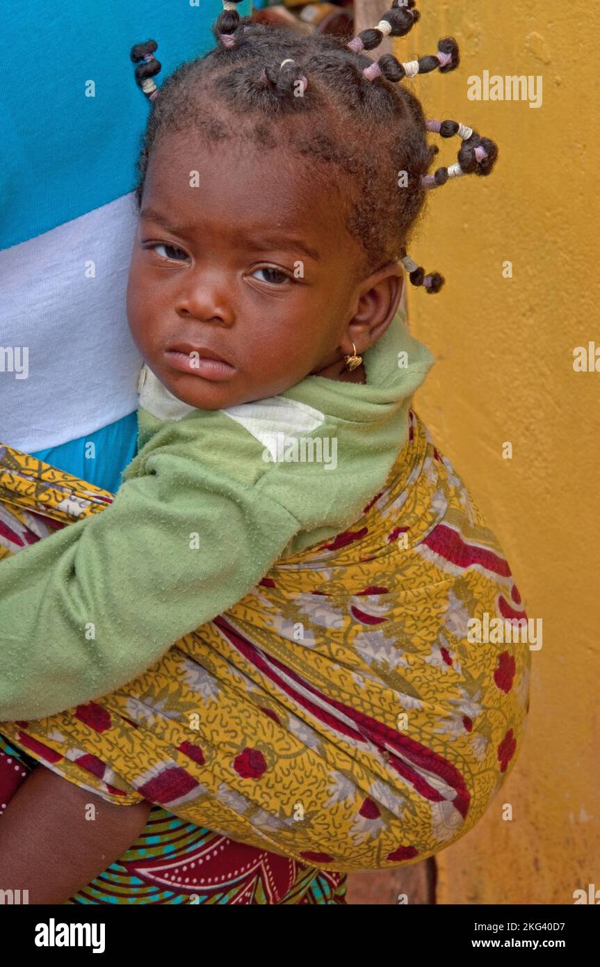 Sleepy baby carried on mother's back, Atacora, Benin Stock Photo - Alamy