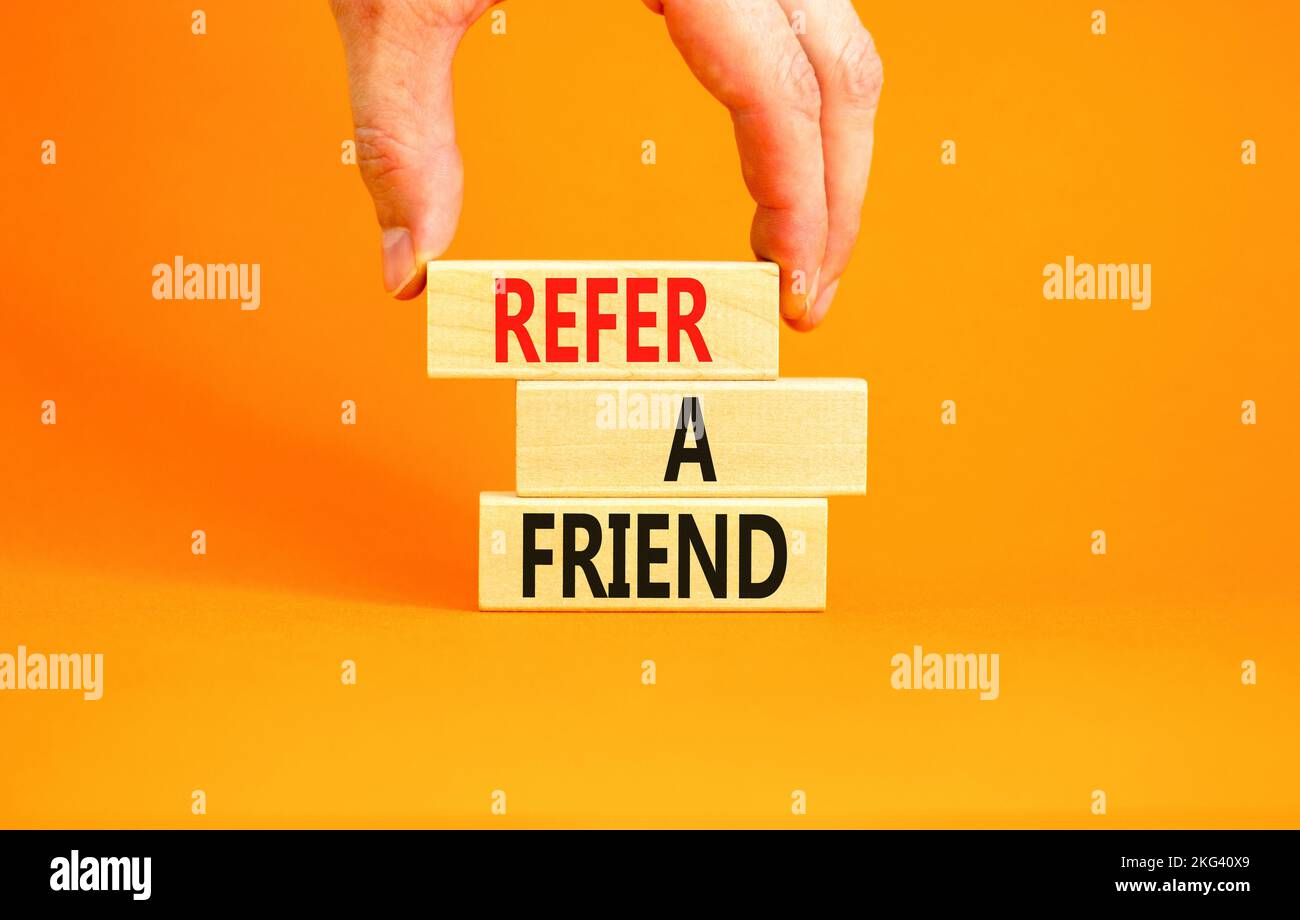 Refer a friend symbol. Concept words Refer a friend on wooden blocks on ...