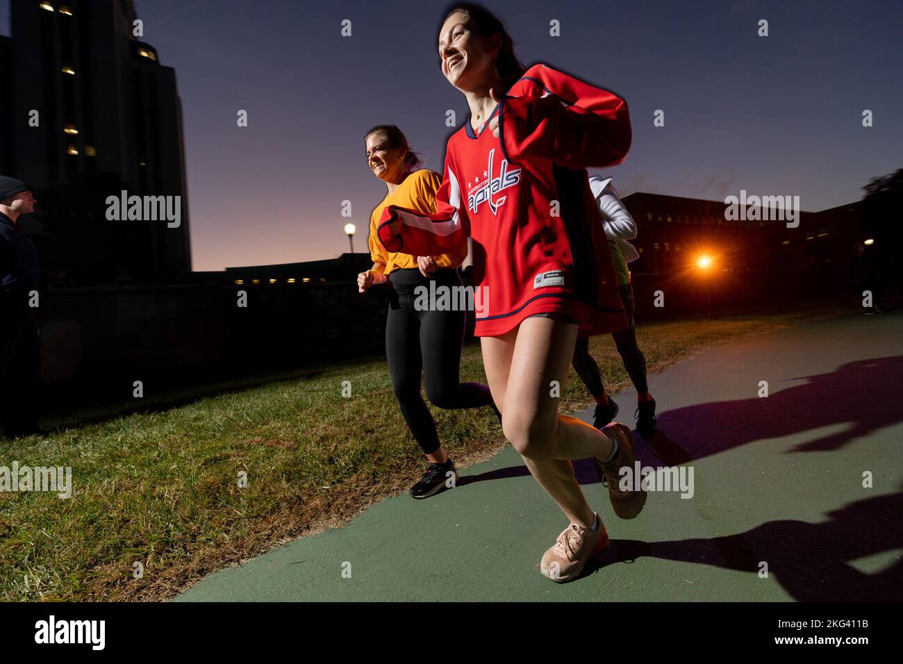 Sailors and Soldiers run in a Halloween 5K Run on the track in front of ...