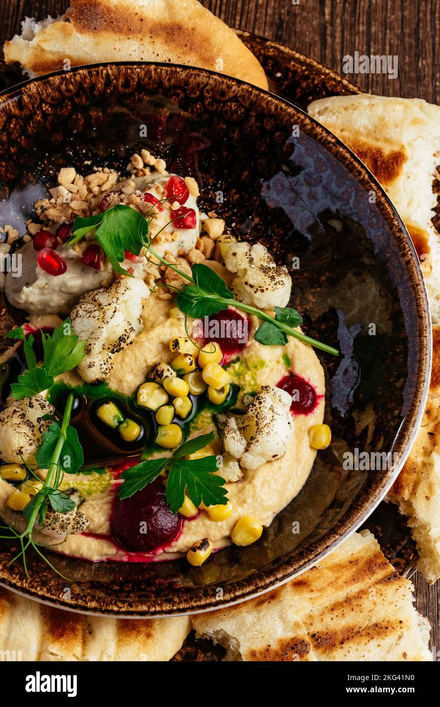hummus with butter, herbs and pitta Stock Photo - Alamy