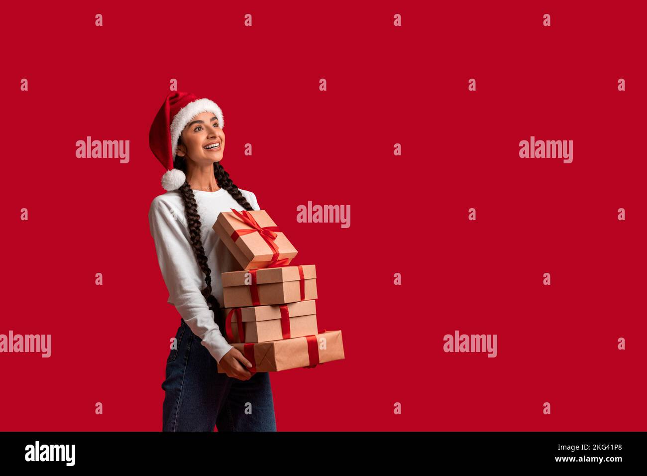 Beautiful Arab Woman In Santa Hat Holding Stack Of Gift Boxes Stock ...