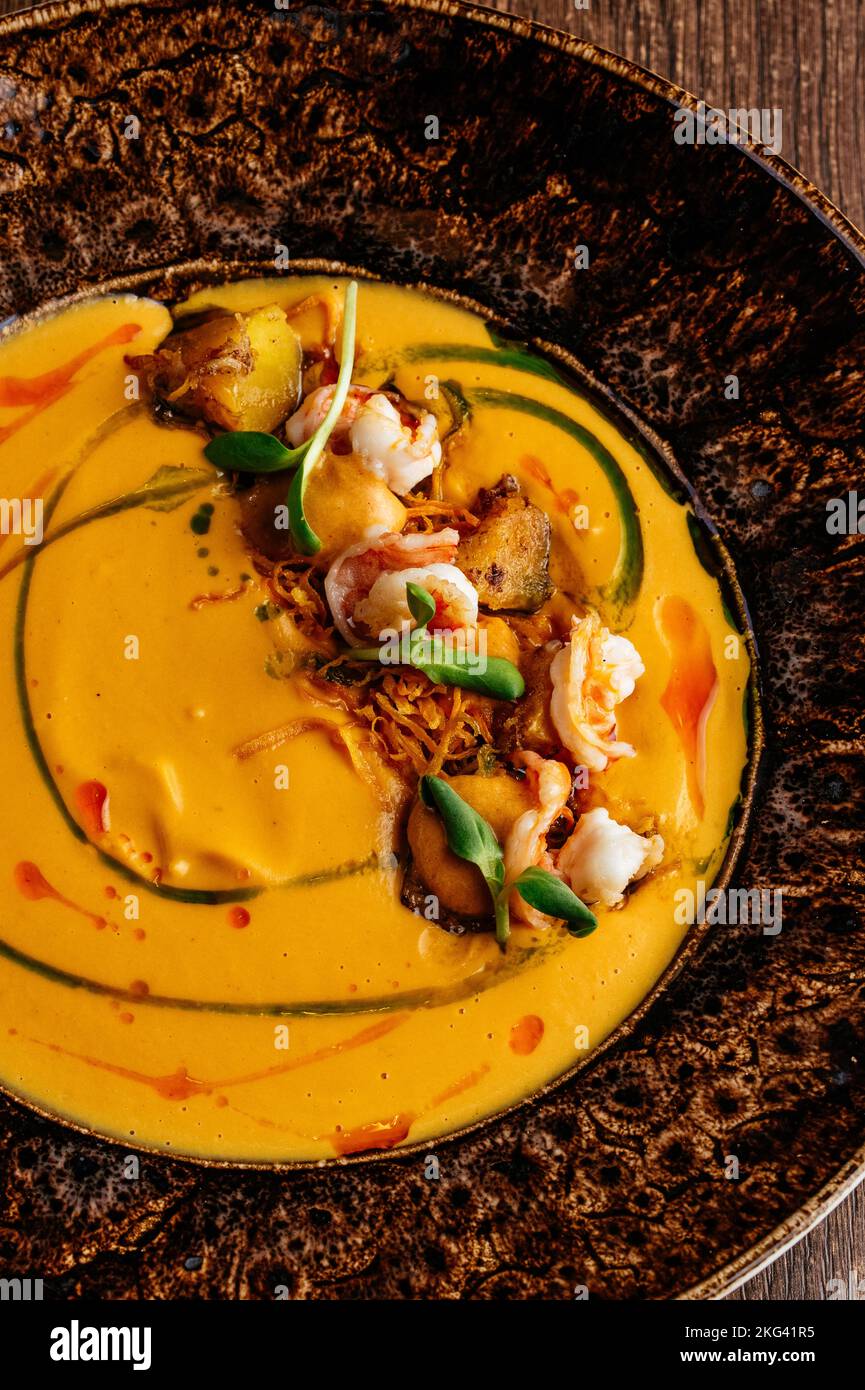 pumpkin cream soup with shrimp Stock Photo - Alamy