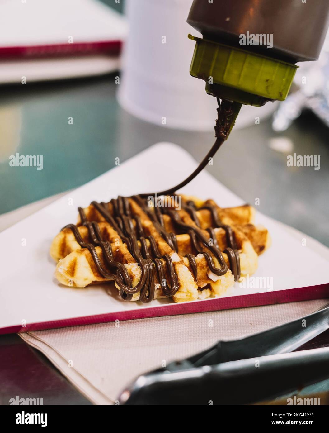 Delicious waffle with chocolate syrup to take on the go Stock Photo - Alamy