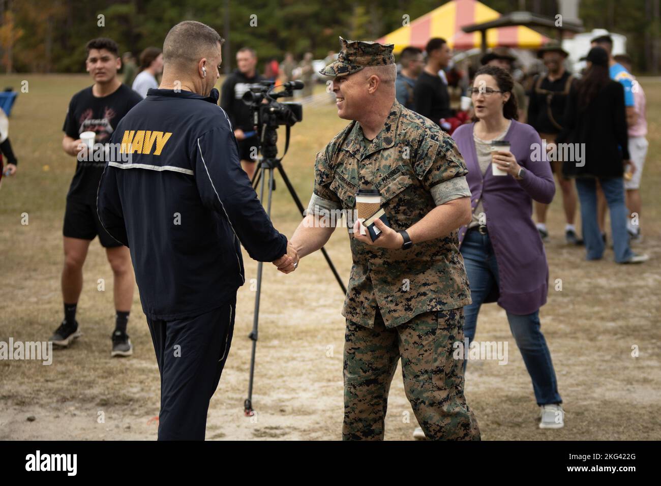 U.S. Navy Lt. Cmdr. Glen Kitzman, left, command chaplain, shakes hands ...