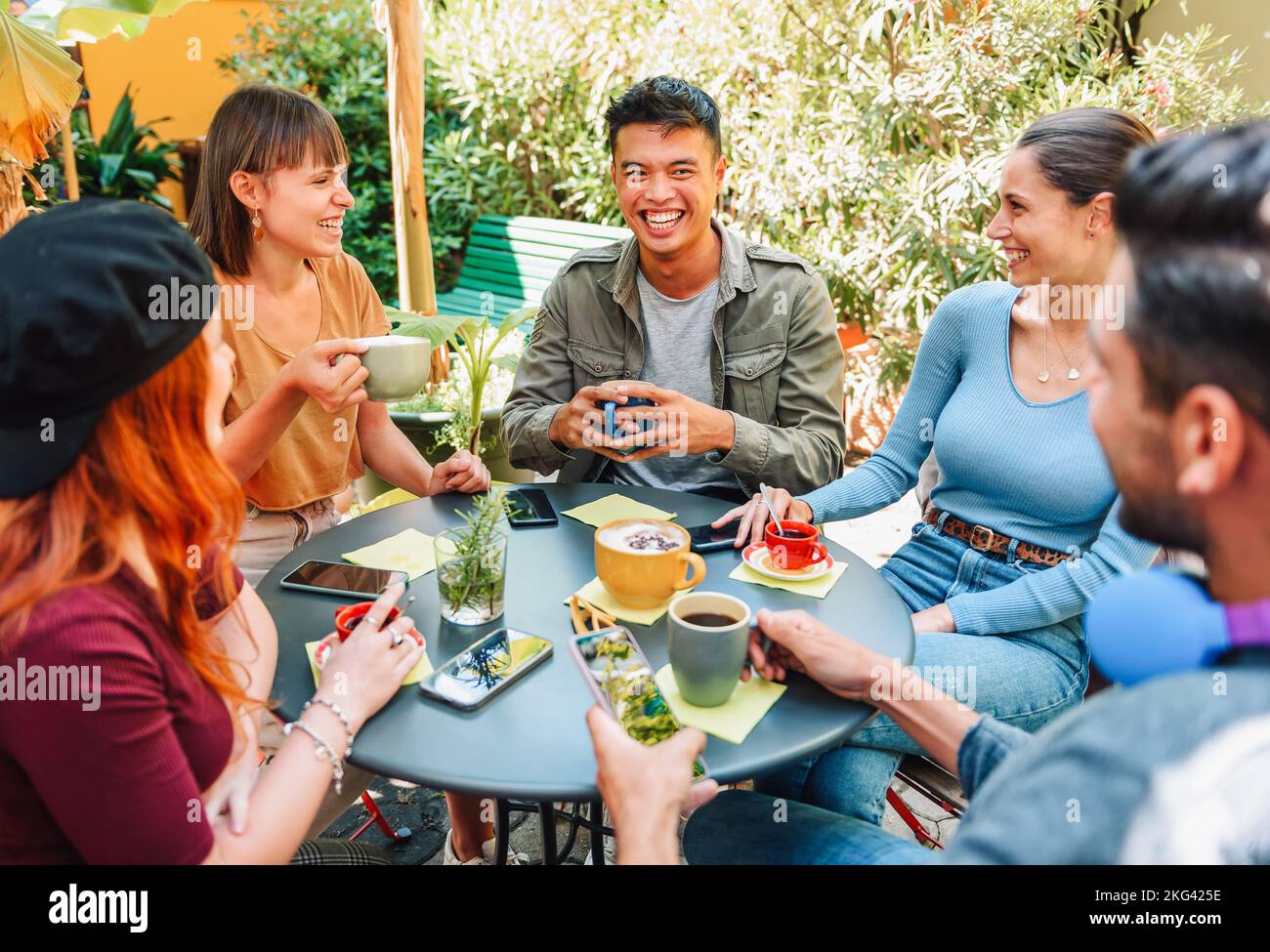 From above group of cheerful multiracial men and women laughing at joke ...
