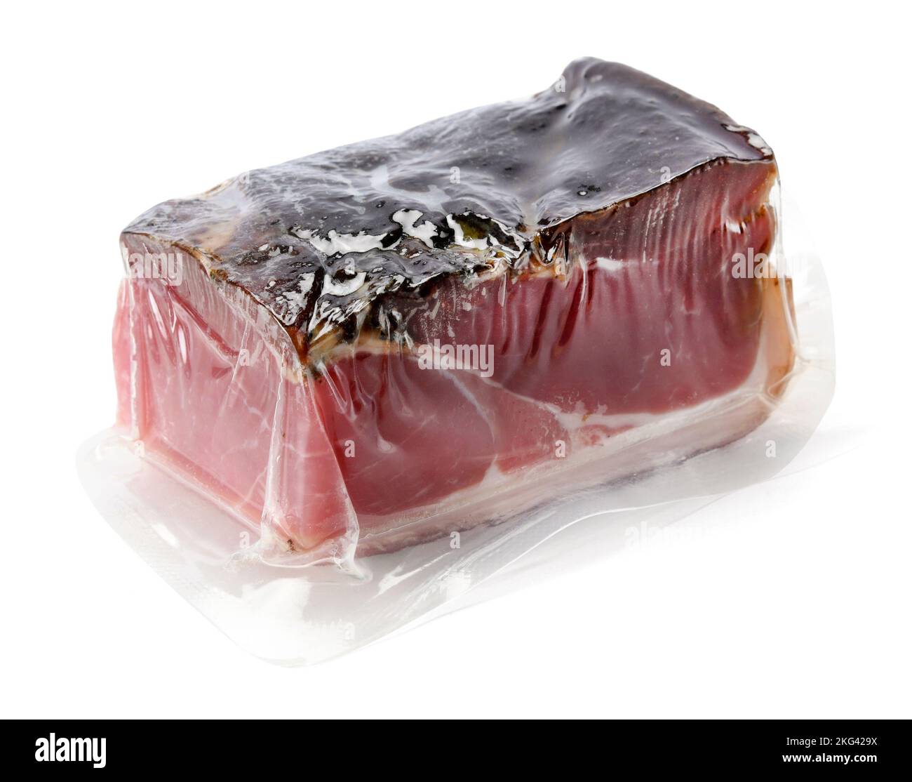 Piece of tasty speck ham packed in vacuum plastic package on white ...