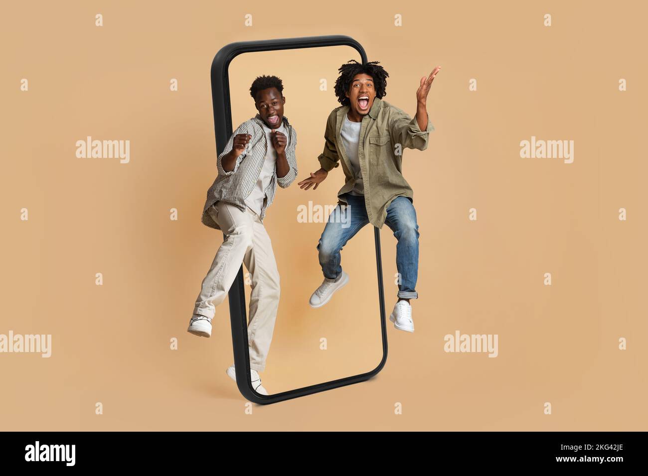 Happy excited young african american guys with open mouths rejoice and ...