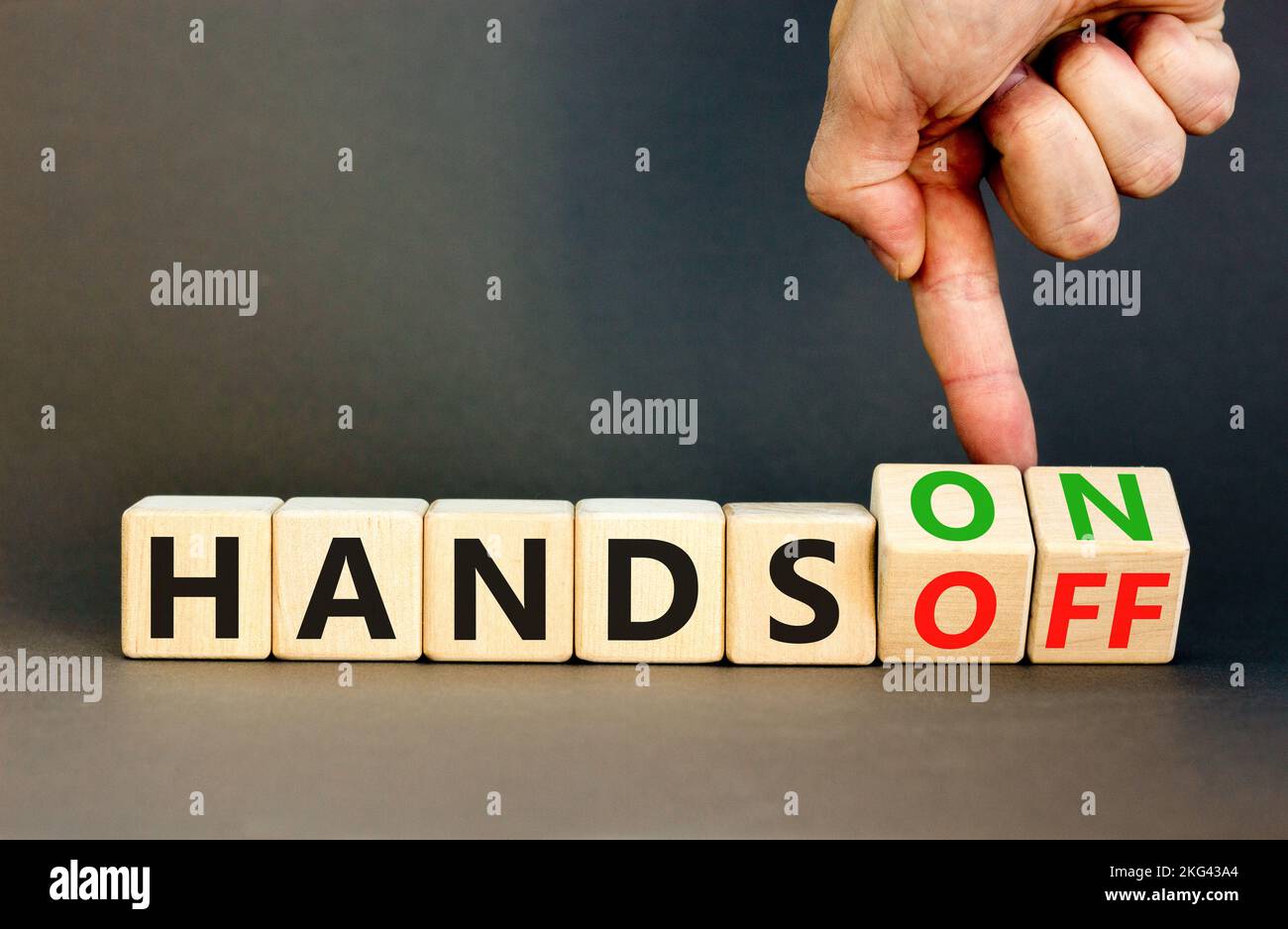 Hands on or off symbol. Concept words Hands on Hands off on wooden cubes. Businessman hand ...