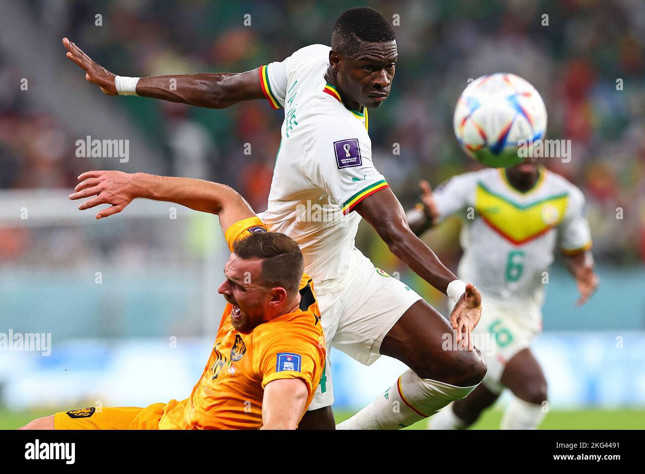 Doha, Qatar. 21st Nov, 2022. Pape Abou Cisse (Top) of Senegal competes ...