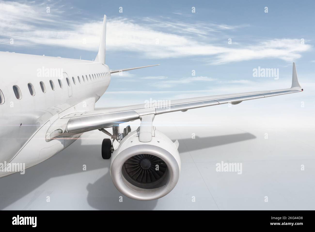 White passenger airplane isolated on bright background with sky. View ...