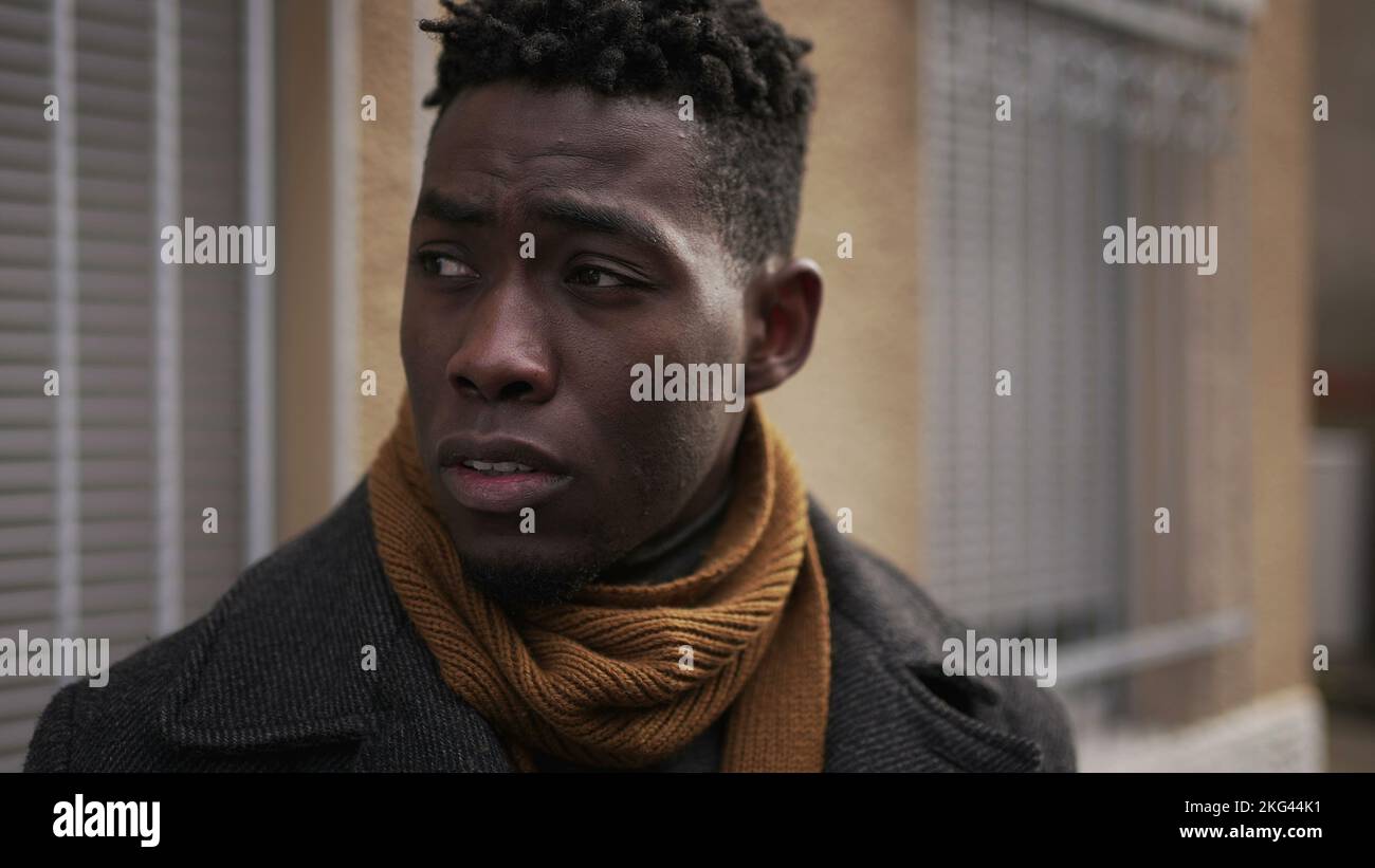 Pensive black man standing outside in city downtown. Thoughtful African ...