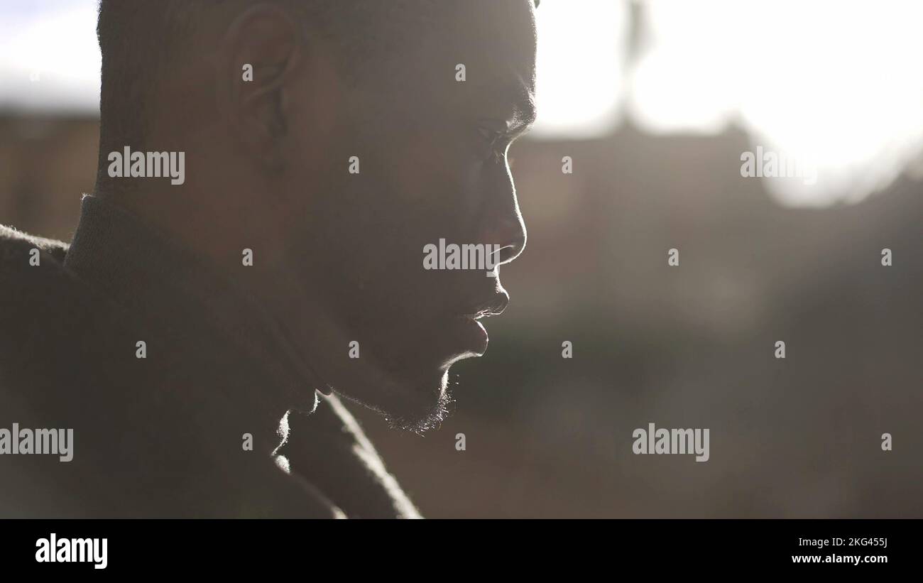 Pensive black man walking outdoors. Introspective pensive African guy ...