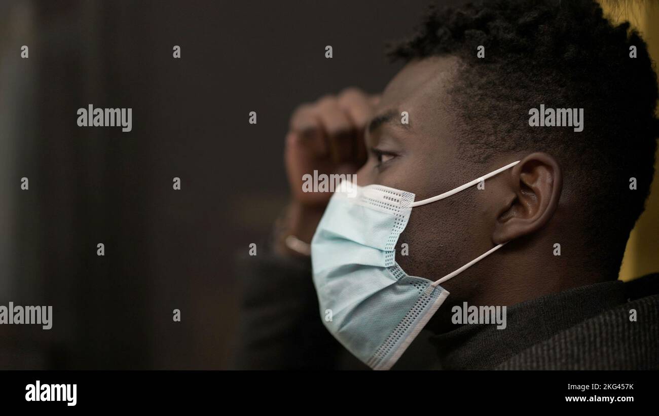 Pensive black man wearing covid-19 face mask inside subway metro Stock ...