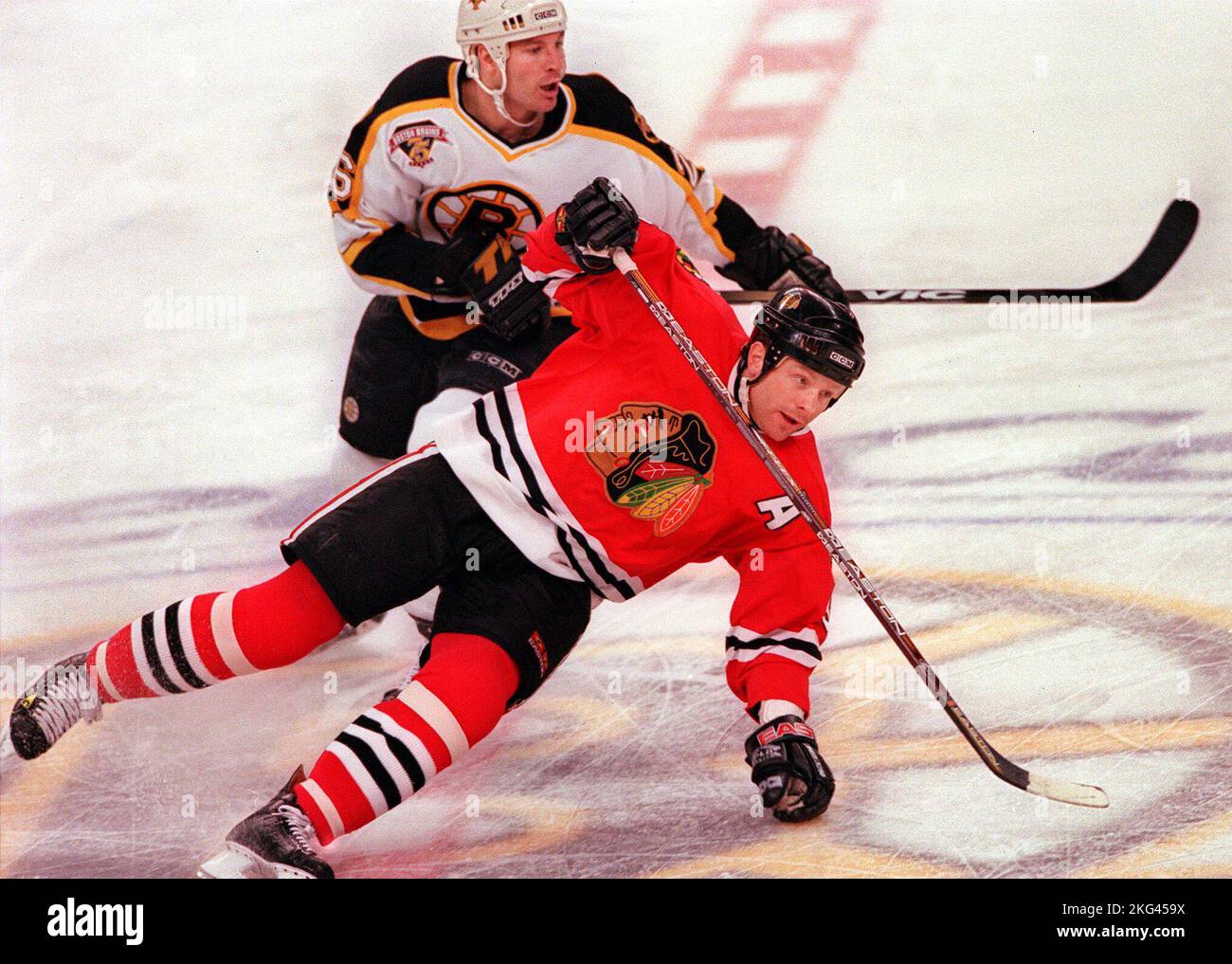 Alexei Zhamnov gets down to ice level with Tim Taylor in hot pursuit ...