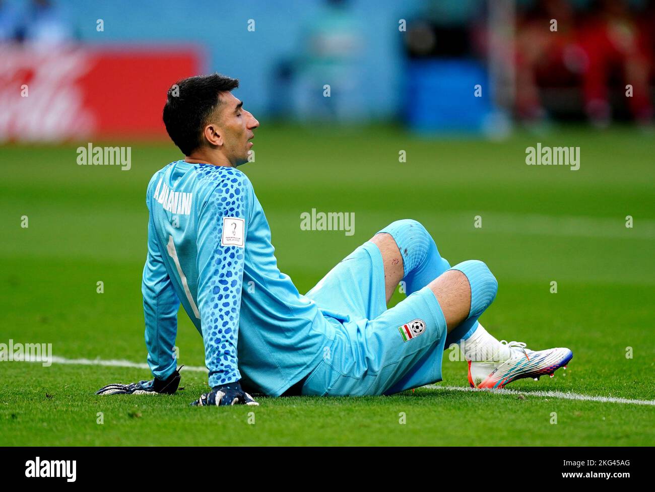 Iran goalkeeper Alireza Beiranvand sits injured on the pitch after suffering a collision during ...