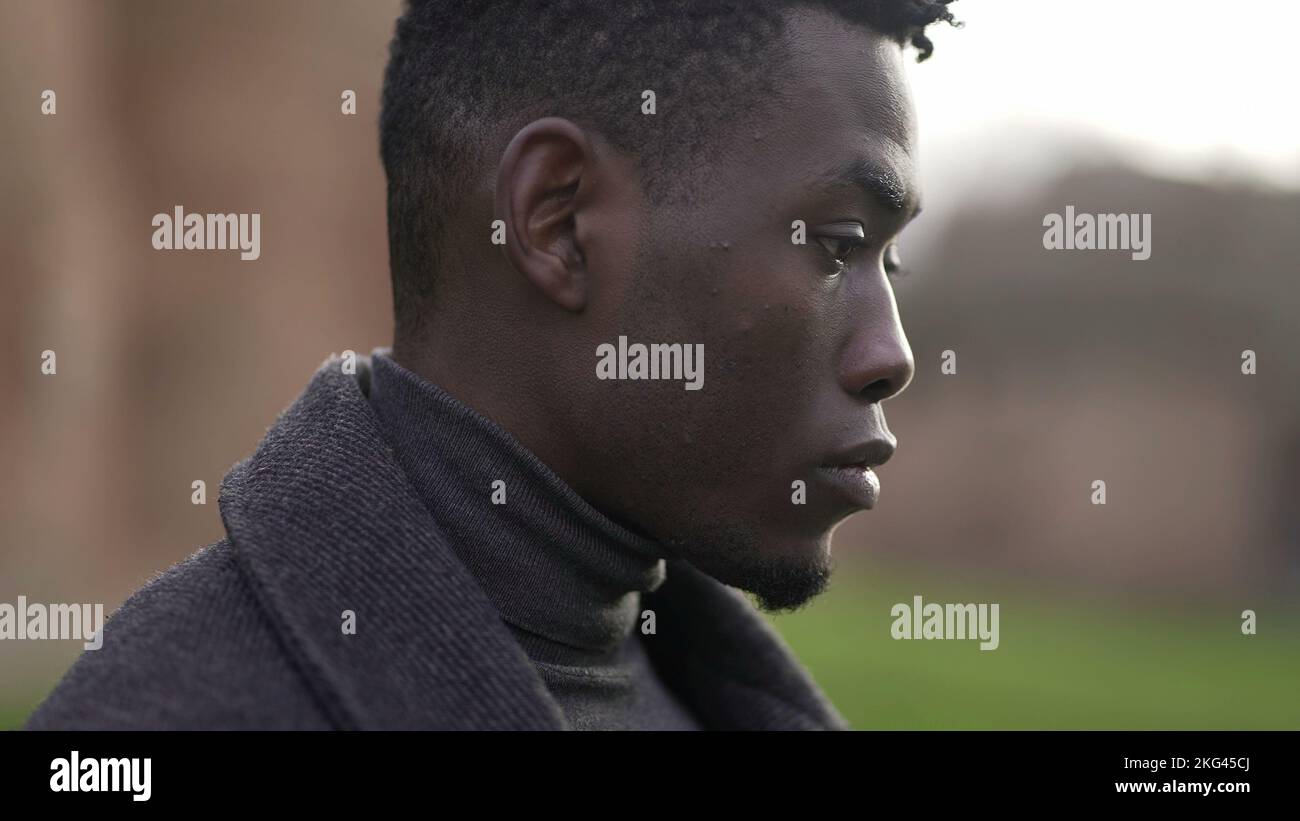 Pensive black African man looking at sky looking for hope Stock Photo ...