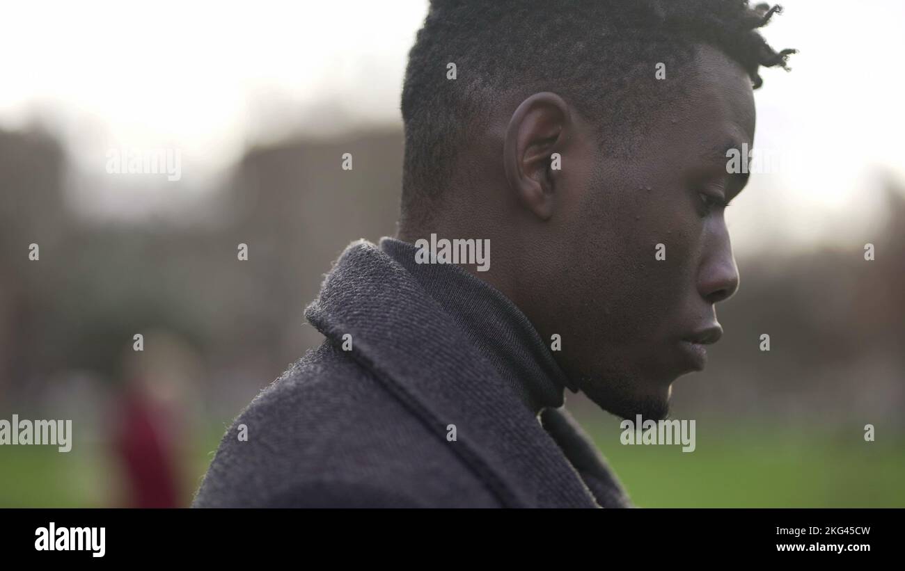 Pensive black African man looking at sky looking for hope Stock Photo ...