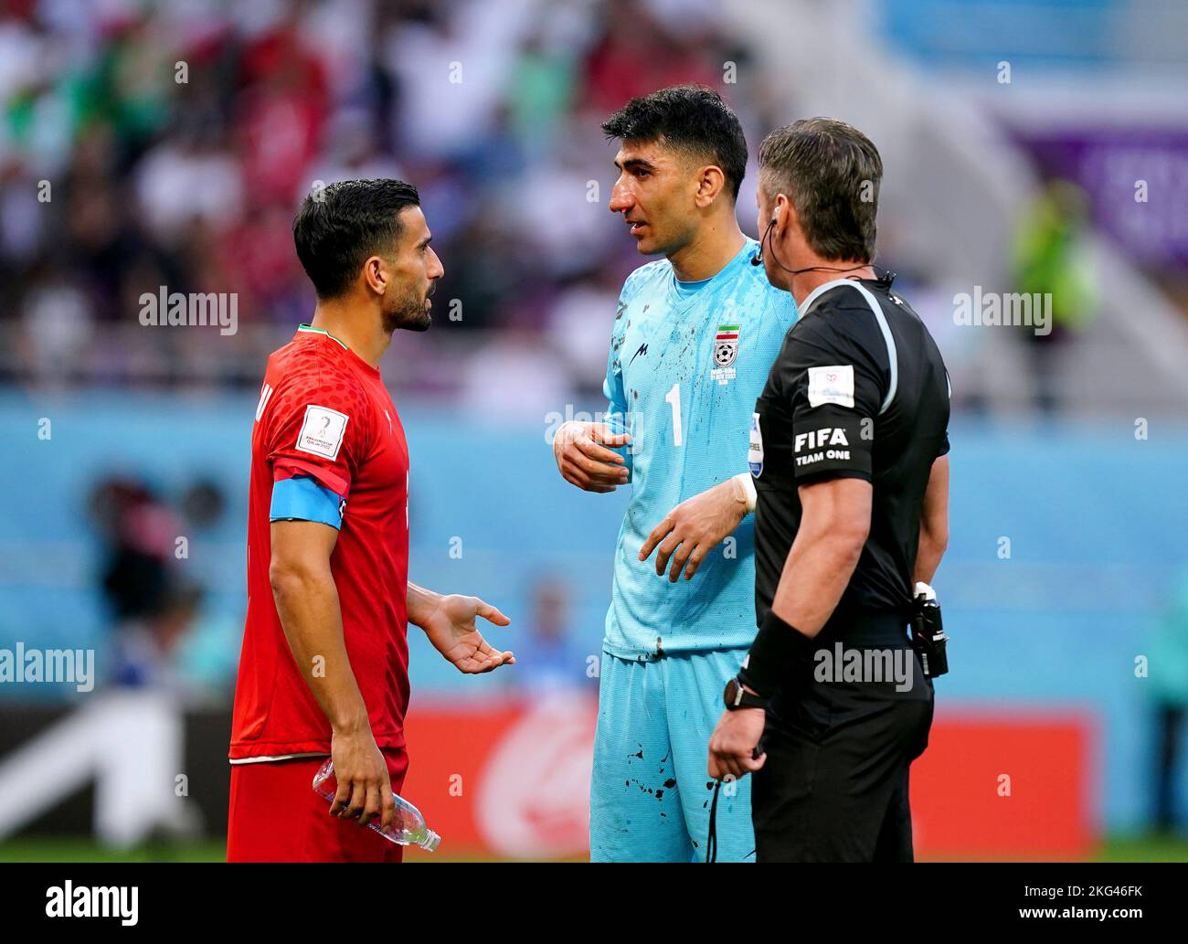 Iran goalkeeper Alireza Beiranvand speaks to team-mate Ehsan Hajsafi ...
