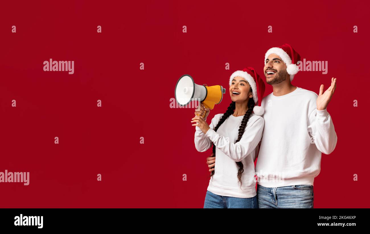 Arab Couple In Santa Hats Making Announcement With Loudspeaker Over Red ...