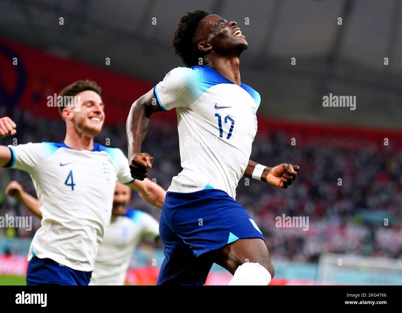 England's Bukayo Saka (right) celebrates scoring their side's second ...