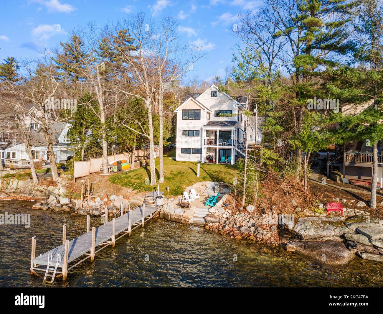 A scenic view of a beautiful white modern house near the lake on a ...
