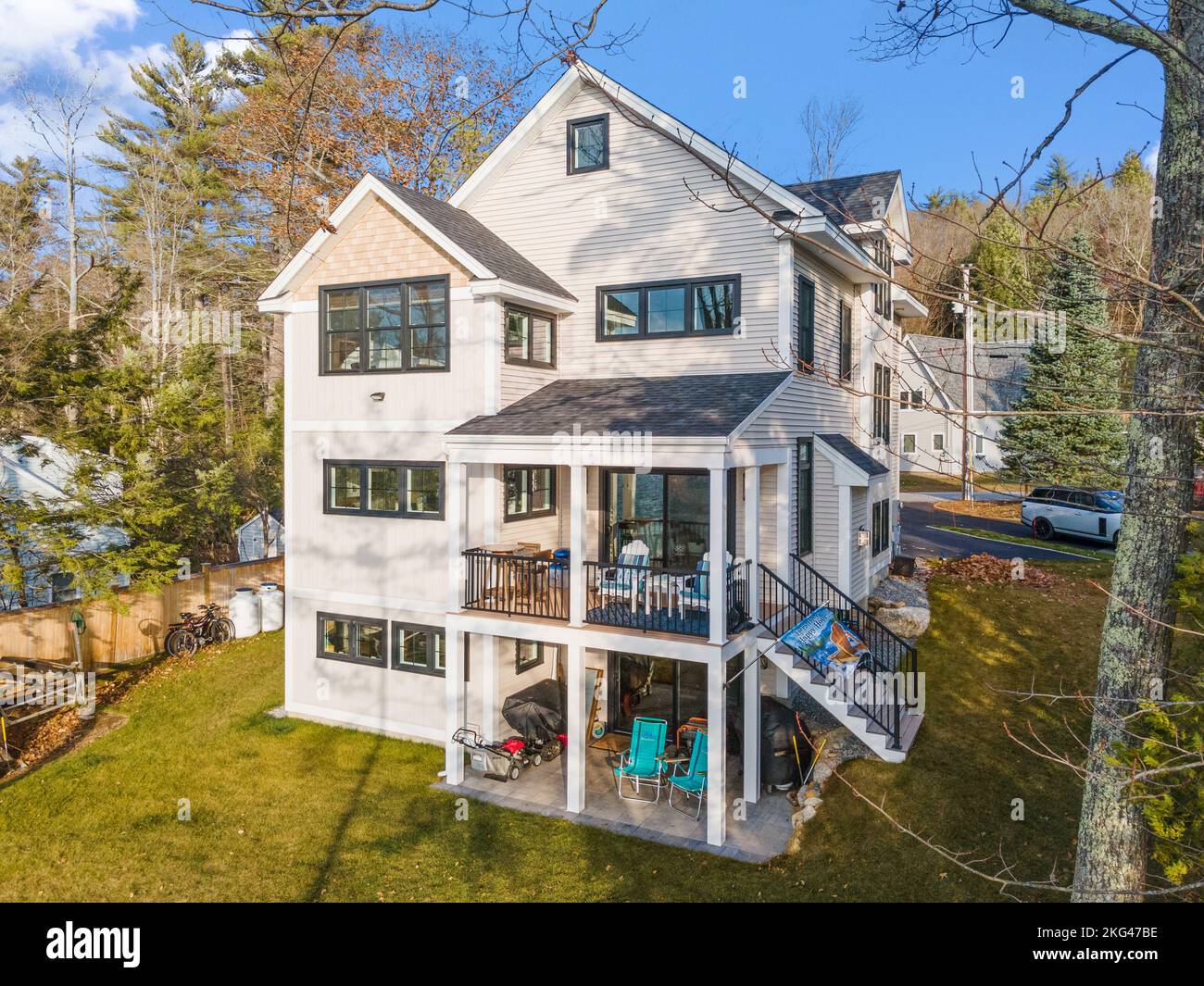 A scenic view of a beautiful white modern house near the lake on a ...