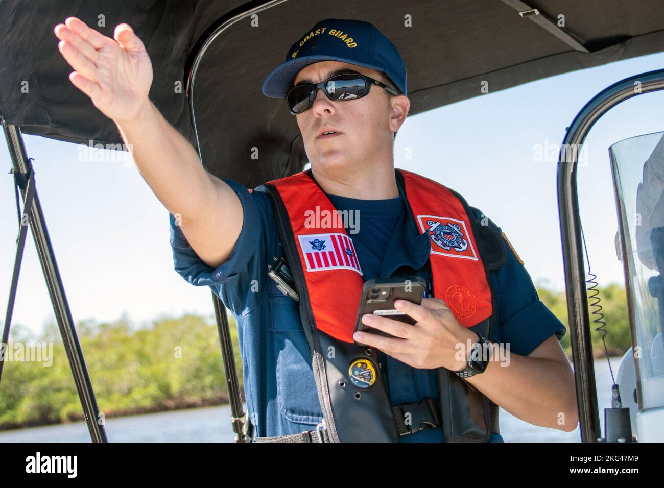 Coast Guard Lt. j.g. Sarah Dupre signals toward marine debris from ...