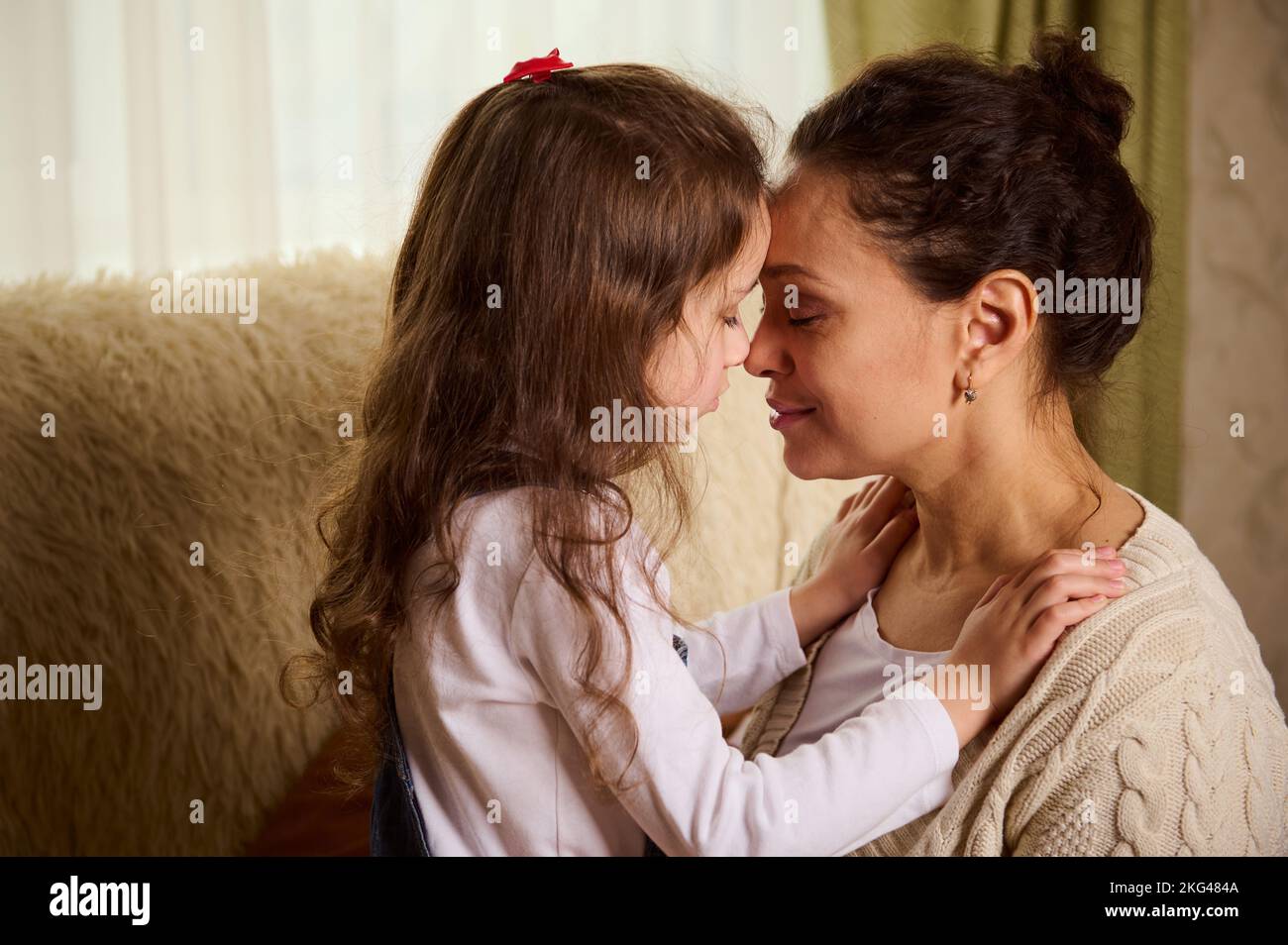 Loving caring mother and daughter hugging each other. Happy carefree childhood. Conscious ...