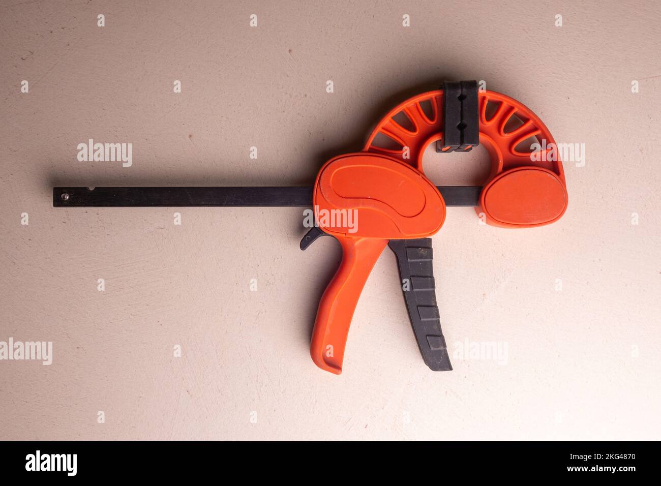 Joiner's clamp made of orange plastic. Joiner's hand tool Stock Photo ...