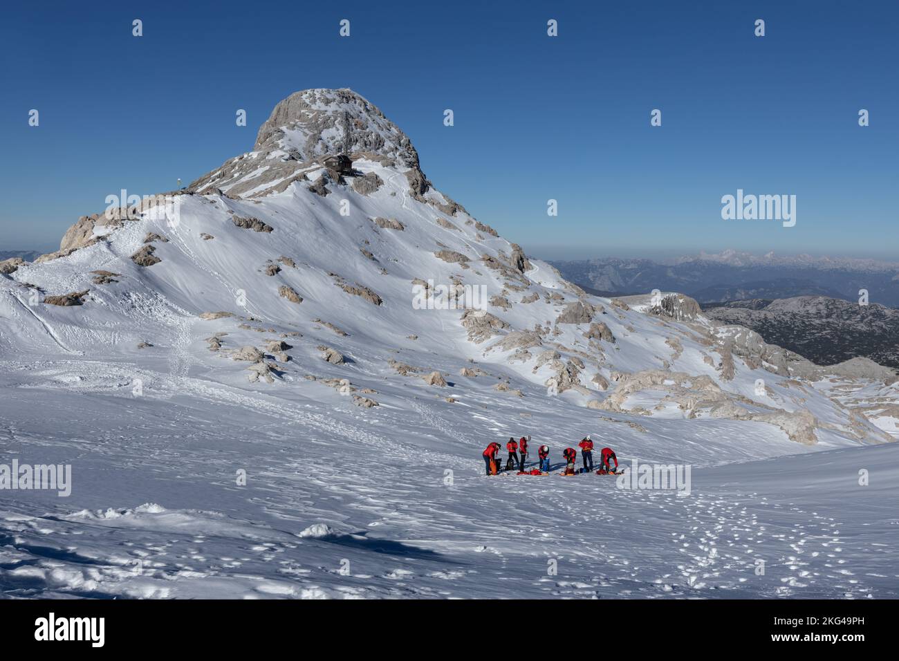 A group of climbers are training on a snowy slope near one of the peaks ...