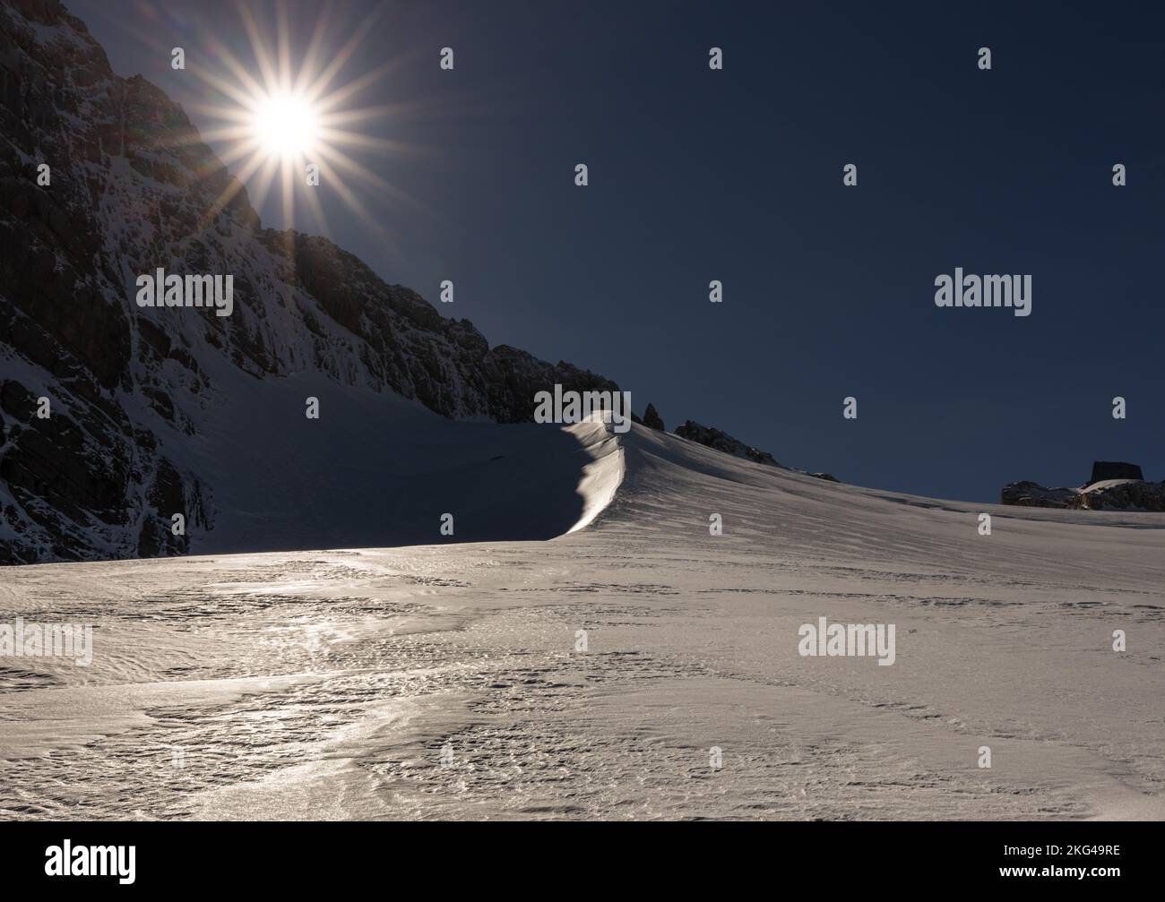 Dachstein mountain range on a clear sunny day, with harsh shadows and ...