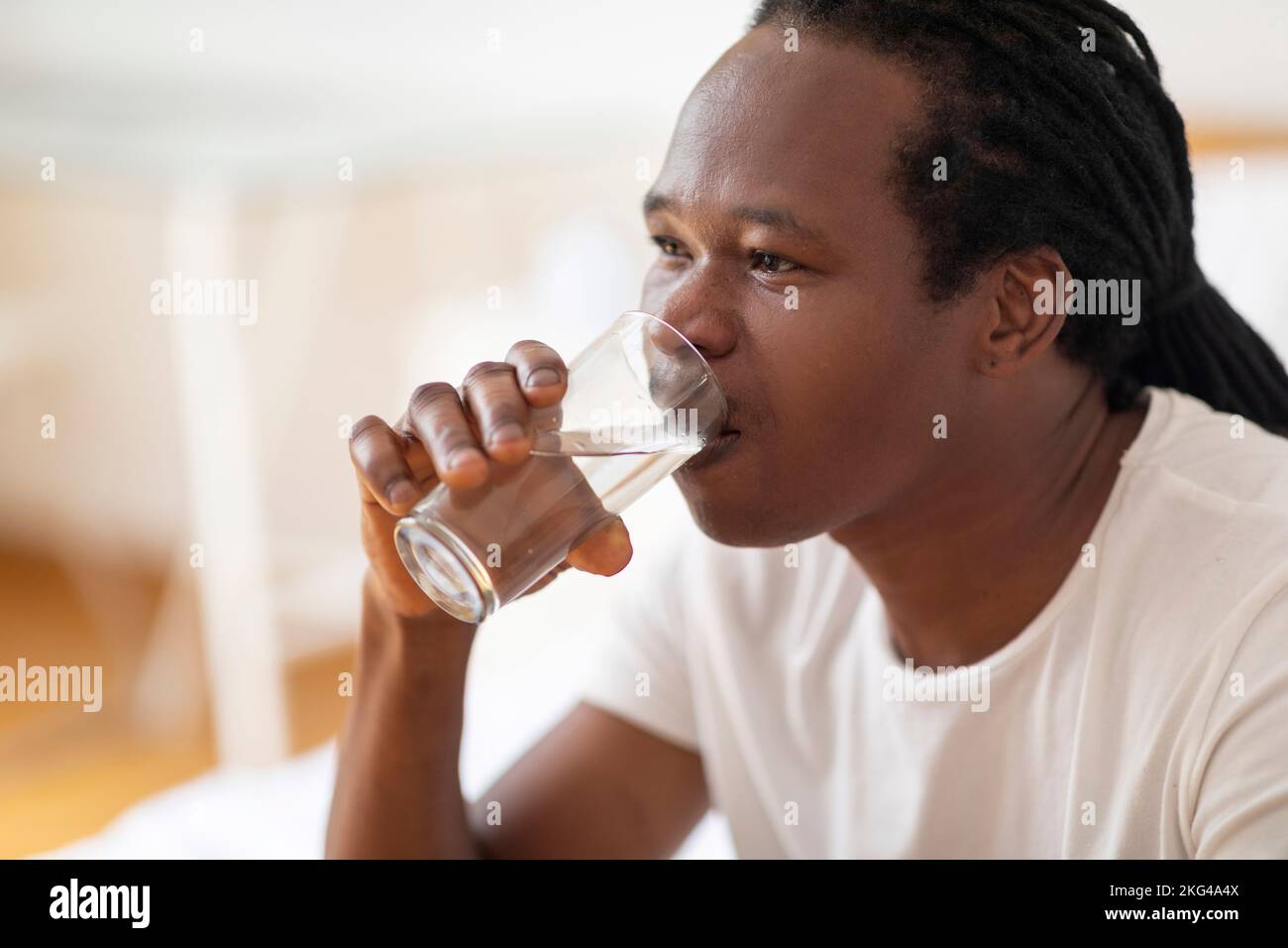 Body Hydration. Black Young Man Drinking Water From Glass At Home Stock ...