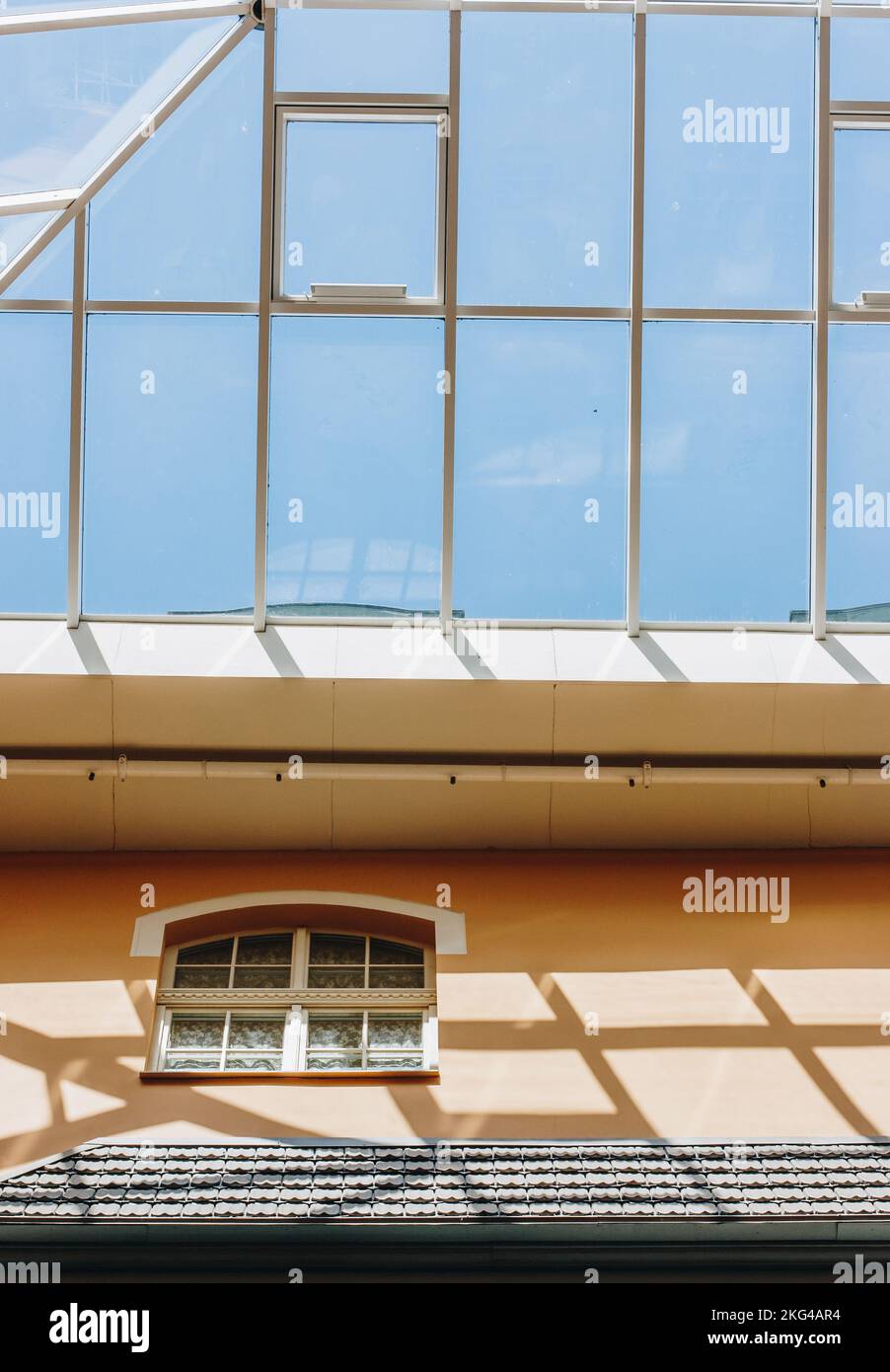 Orange wall of residential house with wooden window and slate balcony ...