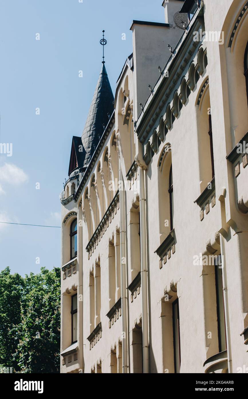 white wall of a residential building with wooden arched windows and a ...