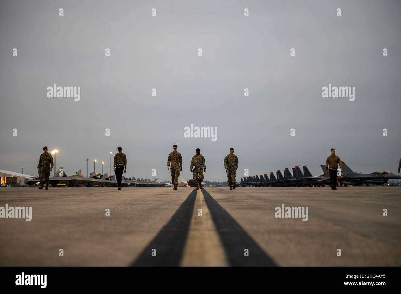 U.S. Airmen perform a foreign object debris walk before the flight line ...