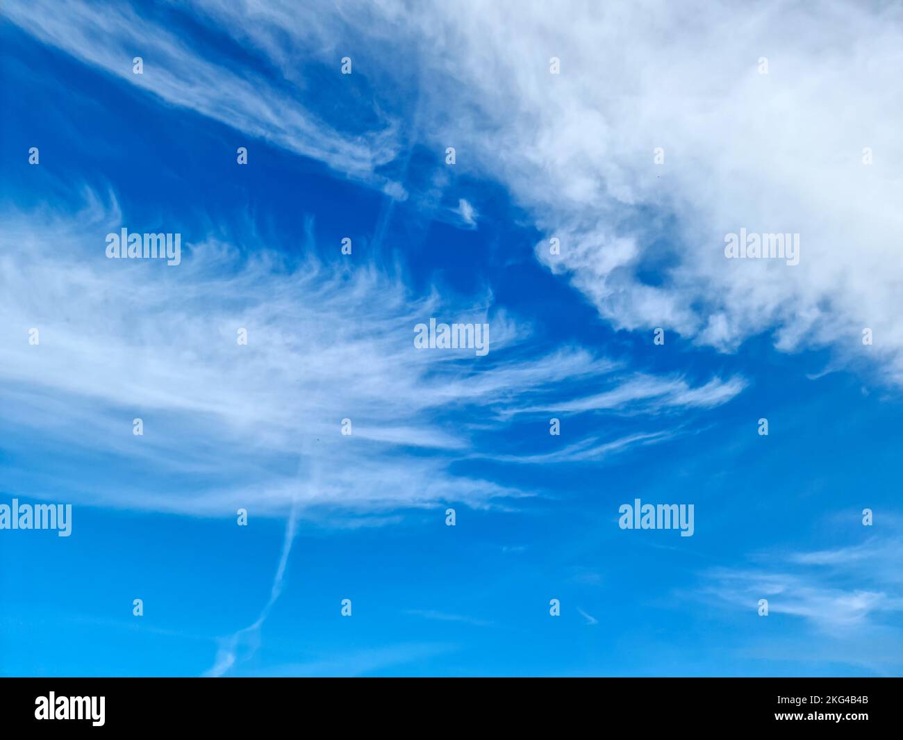 Stunning cirrus cloud formation panorama in a deep blue summer sky seen ...
