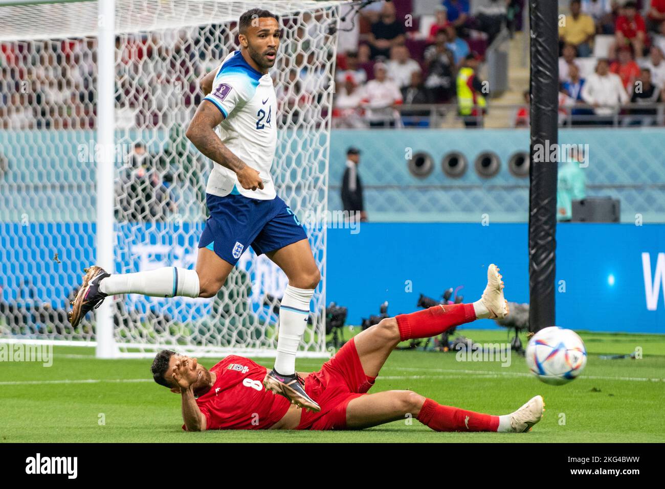 Callum WILSON of England jumps over Morteza POURALIGANJI of Iran during ...