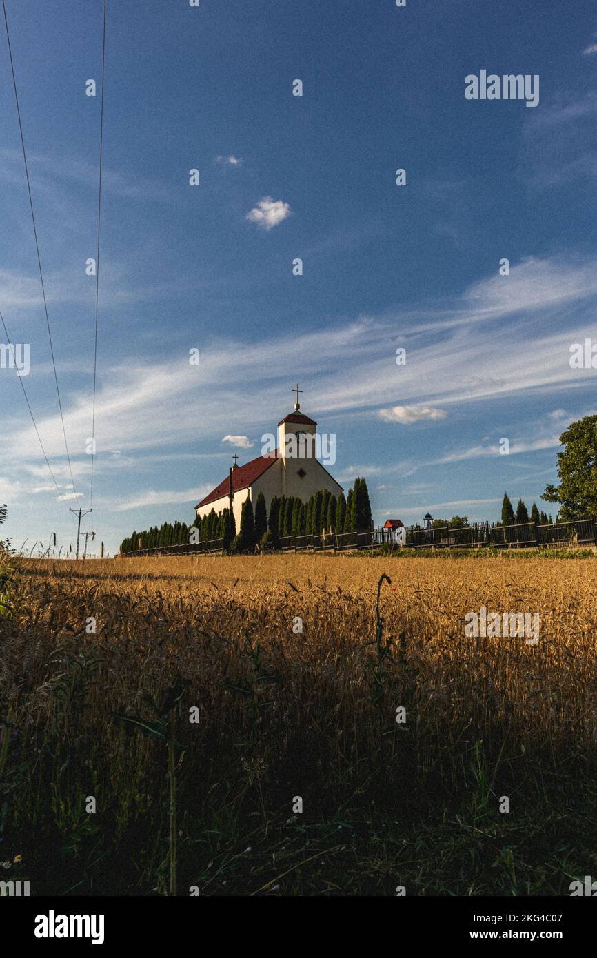 A vertical shot of a church in a field on a sunny day Stock Photo - Alamy
