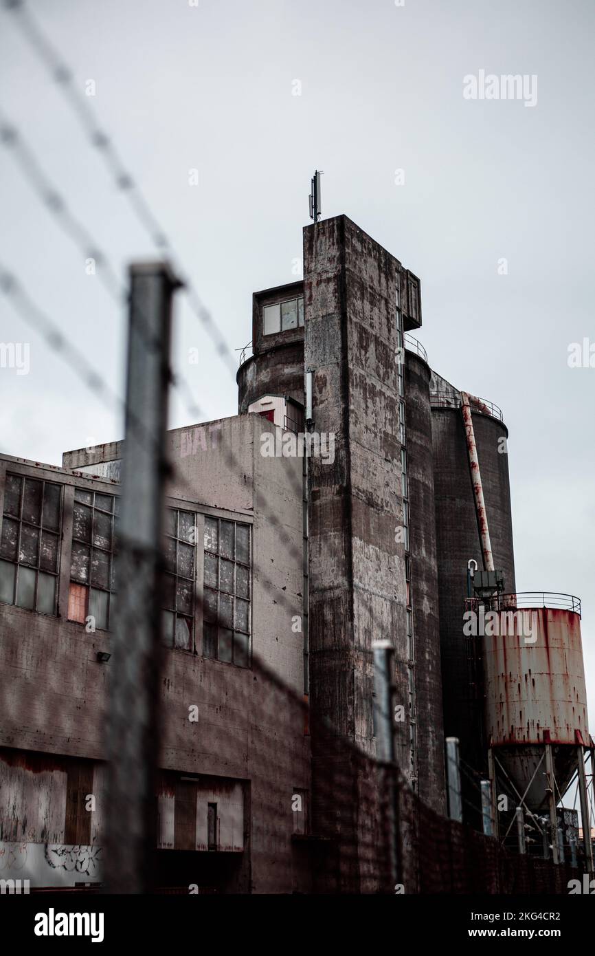 A vertical shot of an old factory on a cloudy day in Reykjavik, Iceland ...