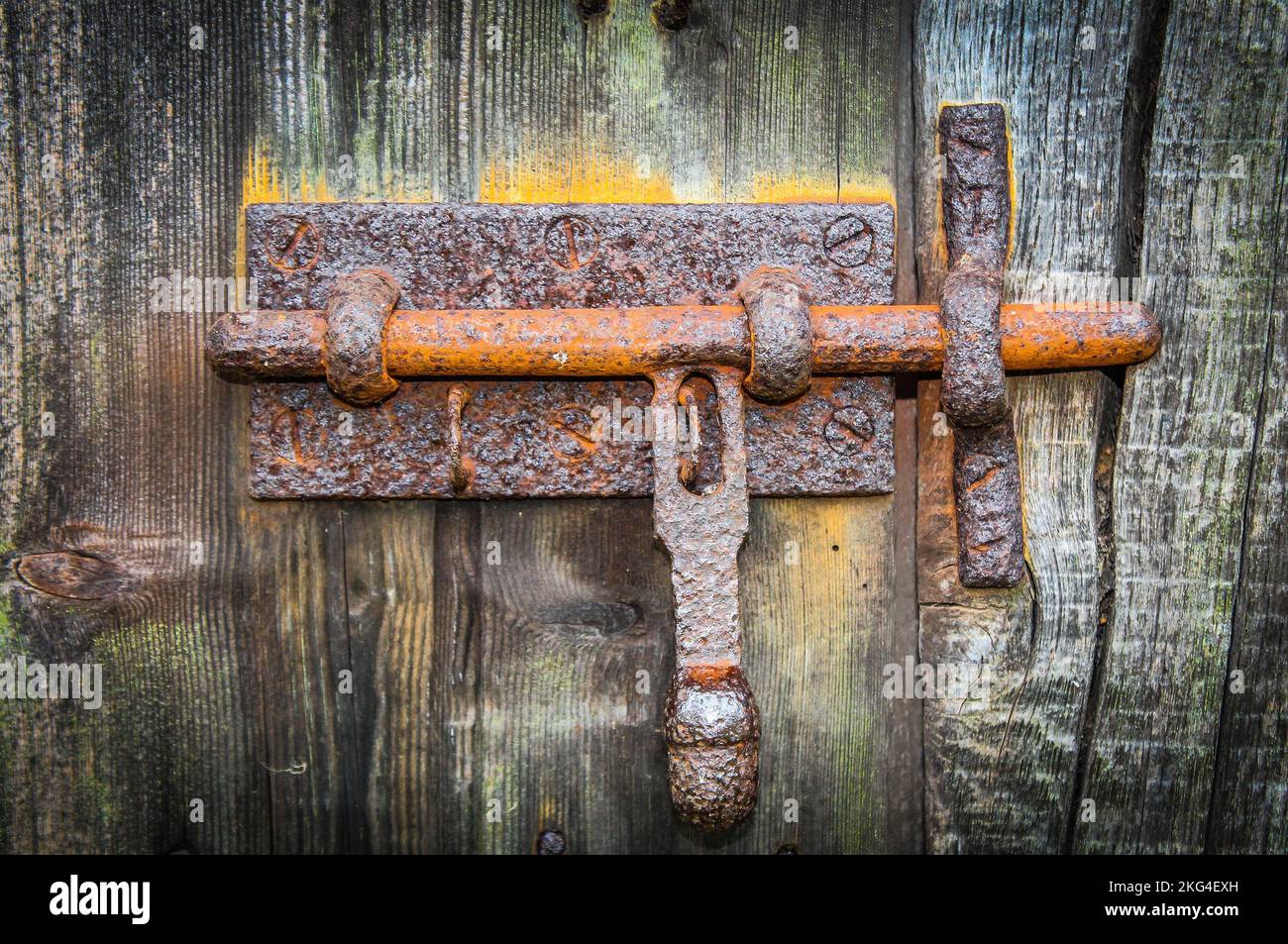 A closeup shot of a rusty metal lock on a wooden door Stock Photo - Alamy